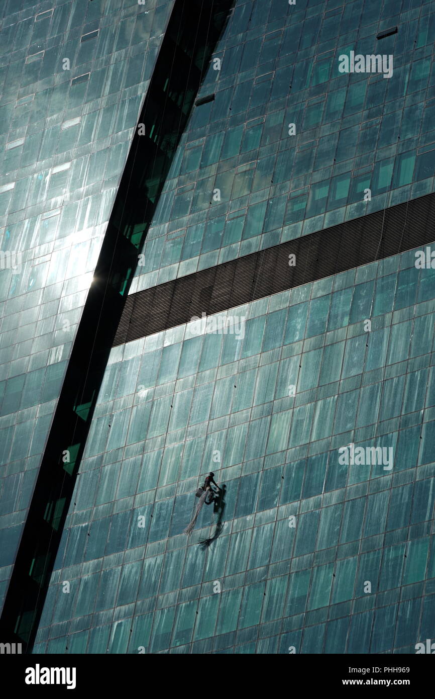 Windows washers cleaning glass facade of a high rise building Stock ...