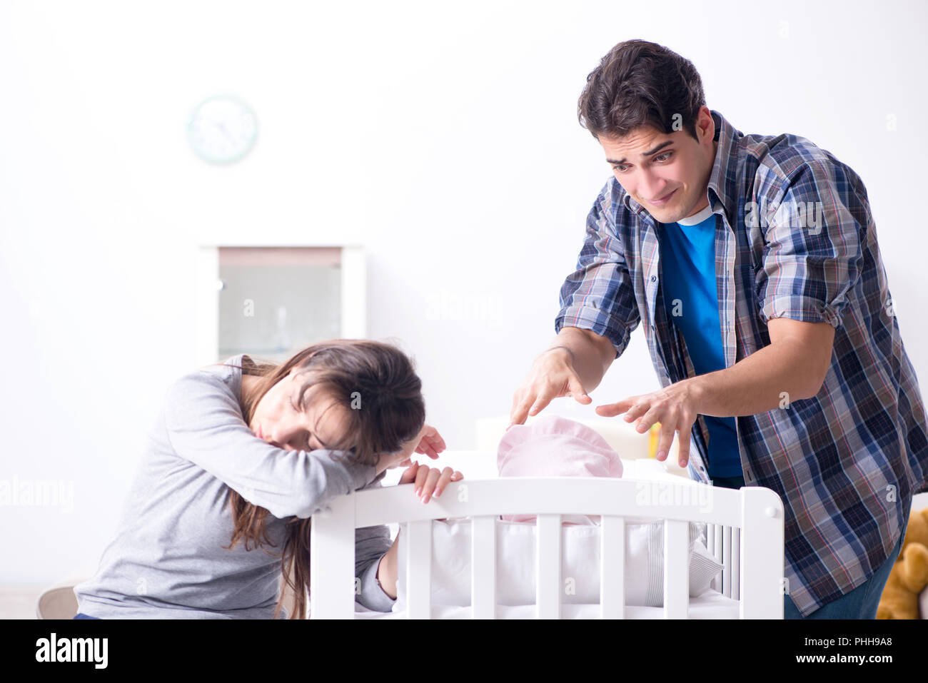 Young dad cannot stand baby crying Stock Photo - Alamy