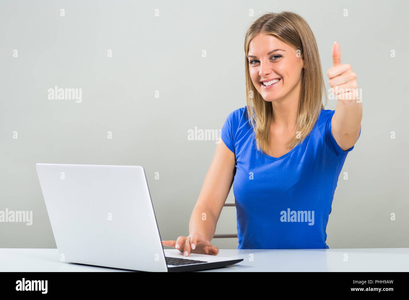 Beautiful female student using laptop and studying Stock Photo - Alamy
