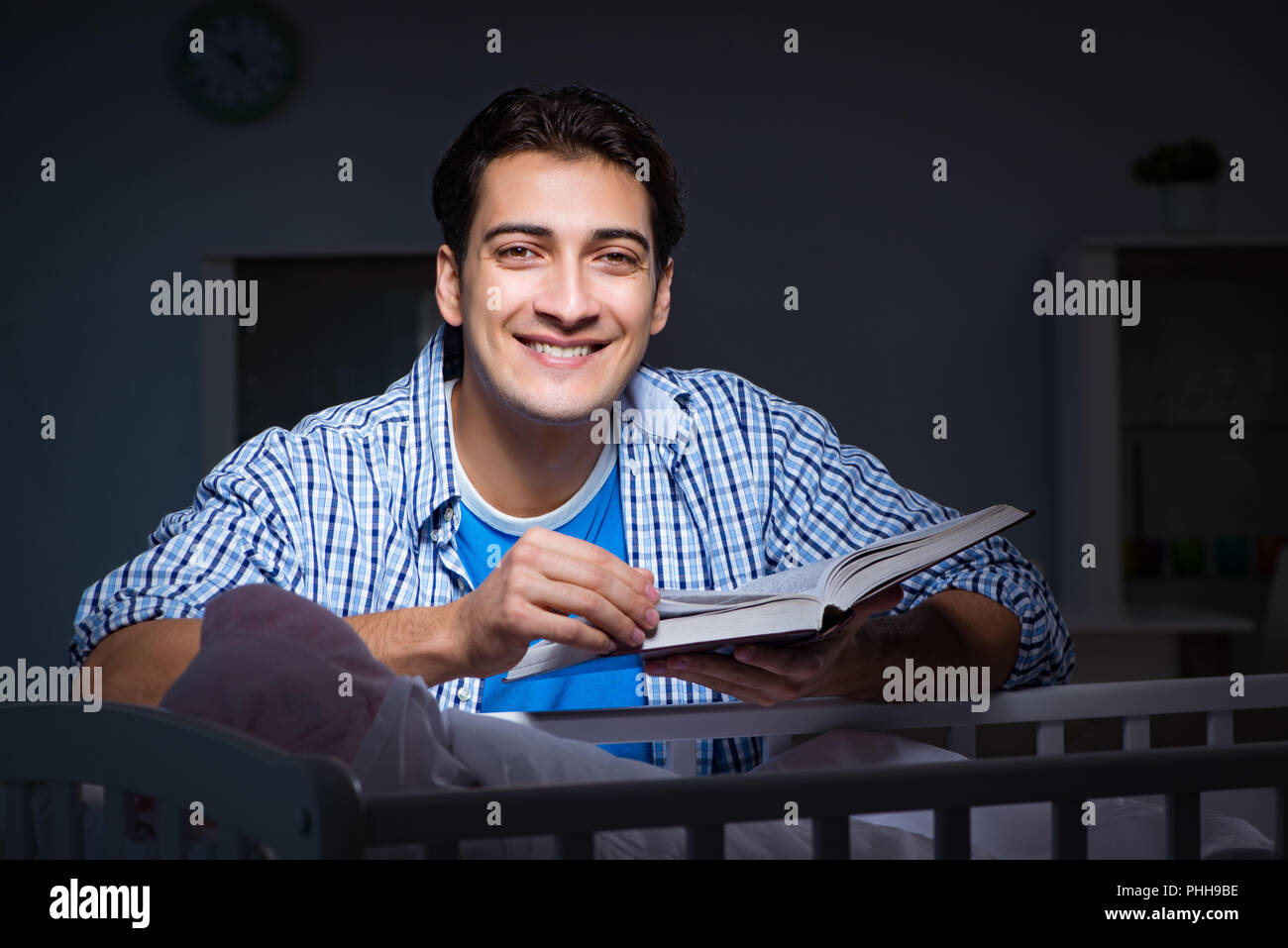 Young student doing homework and looking after newborn baby Stock Photo ...