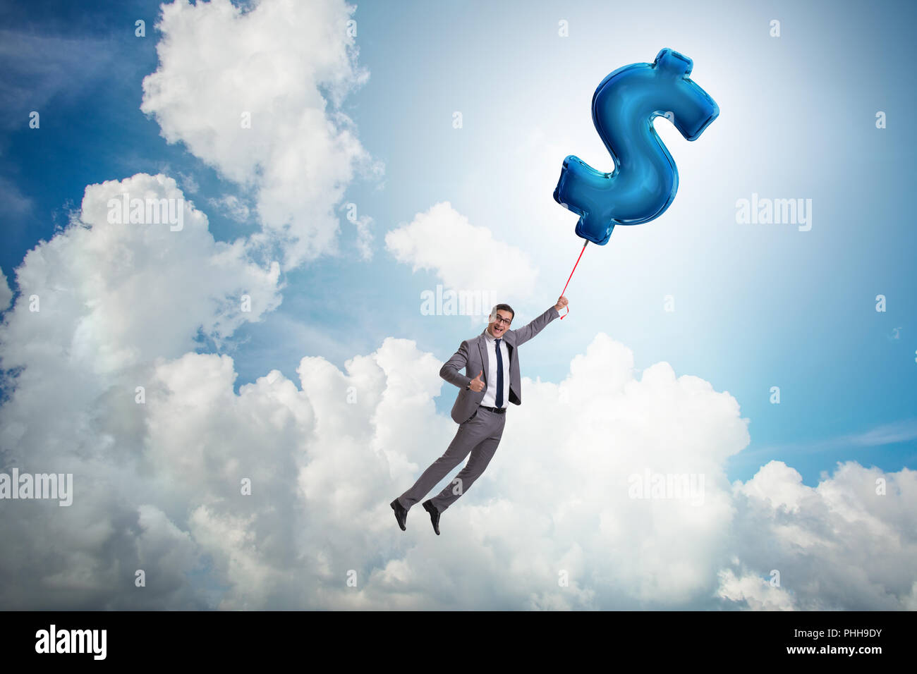 Businessman flying on dollar sign inflatable balloon Stock Photo - Alamy