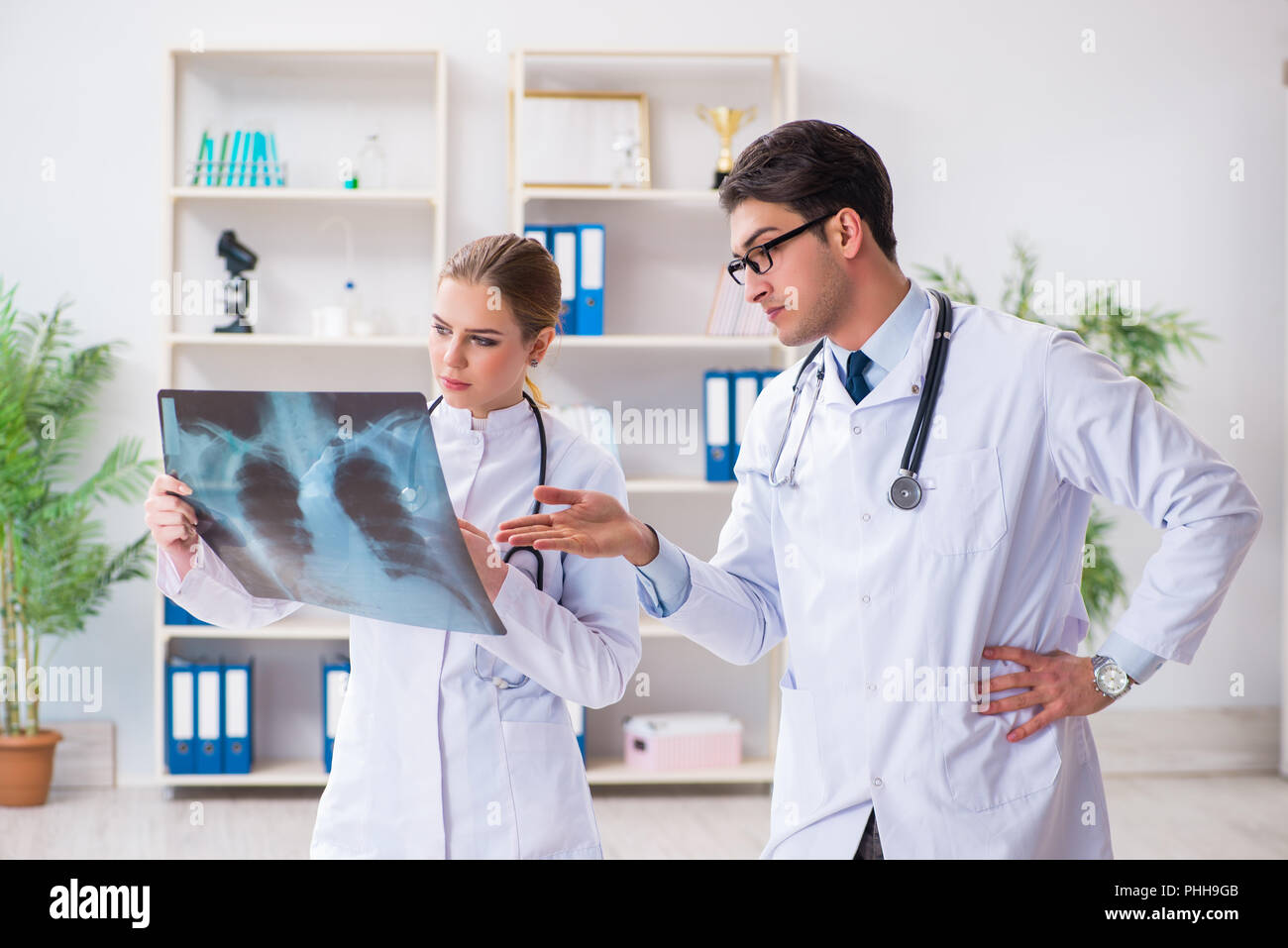 Two doctors examining x-ray images of patient for diagnosis Stock Photo ...