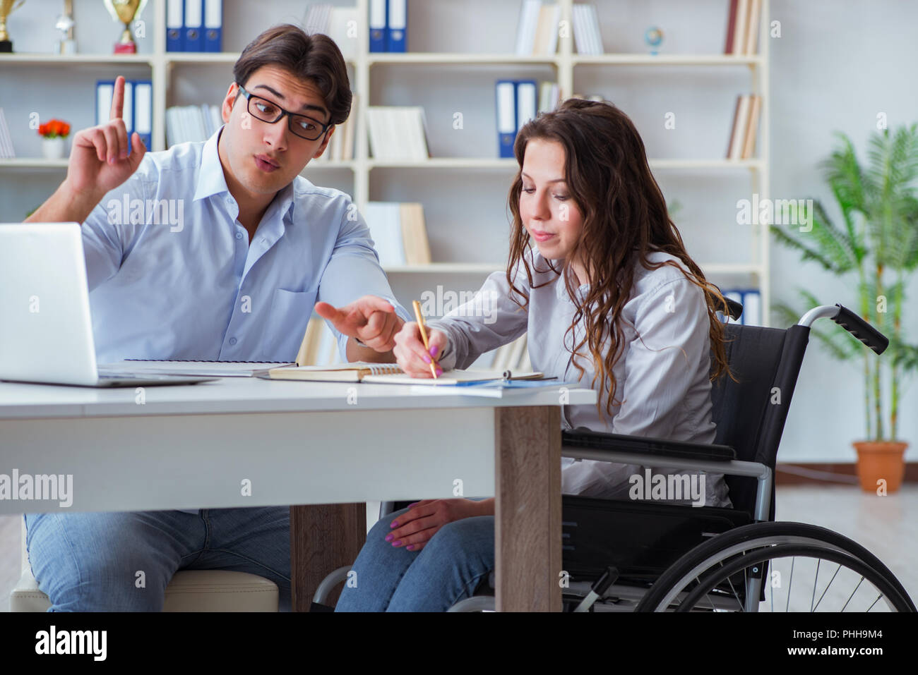 Disabled student studying and preparing for college exams Stock Photo ...