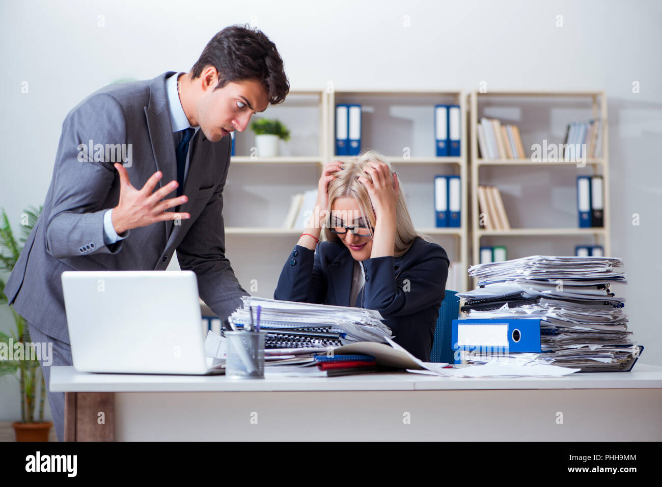 Angry irate boss yelling and shouting at his secretary employee Stock ...