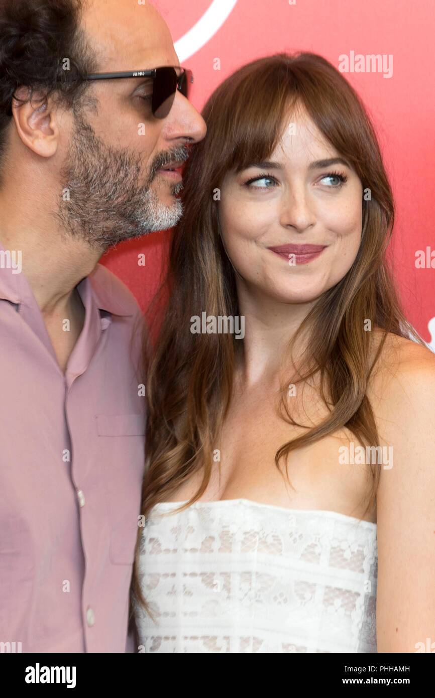 Director Luca Guadagnino and Dakota Johnson pose at the photo call of ...
