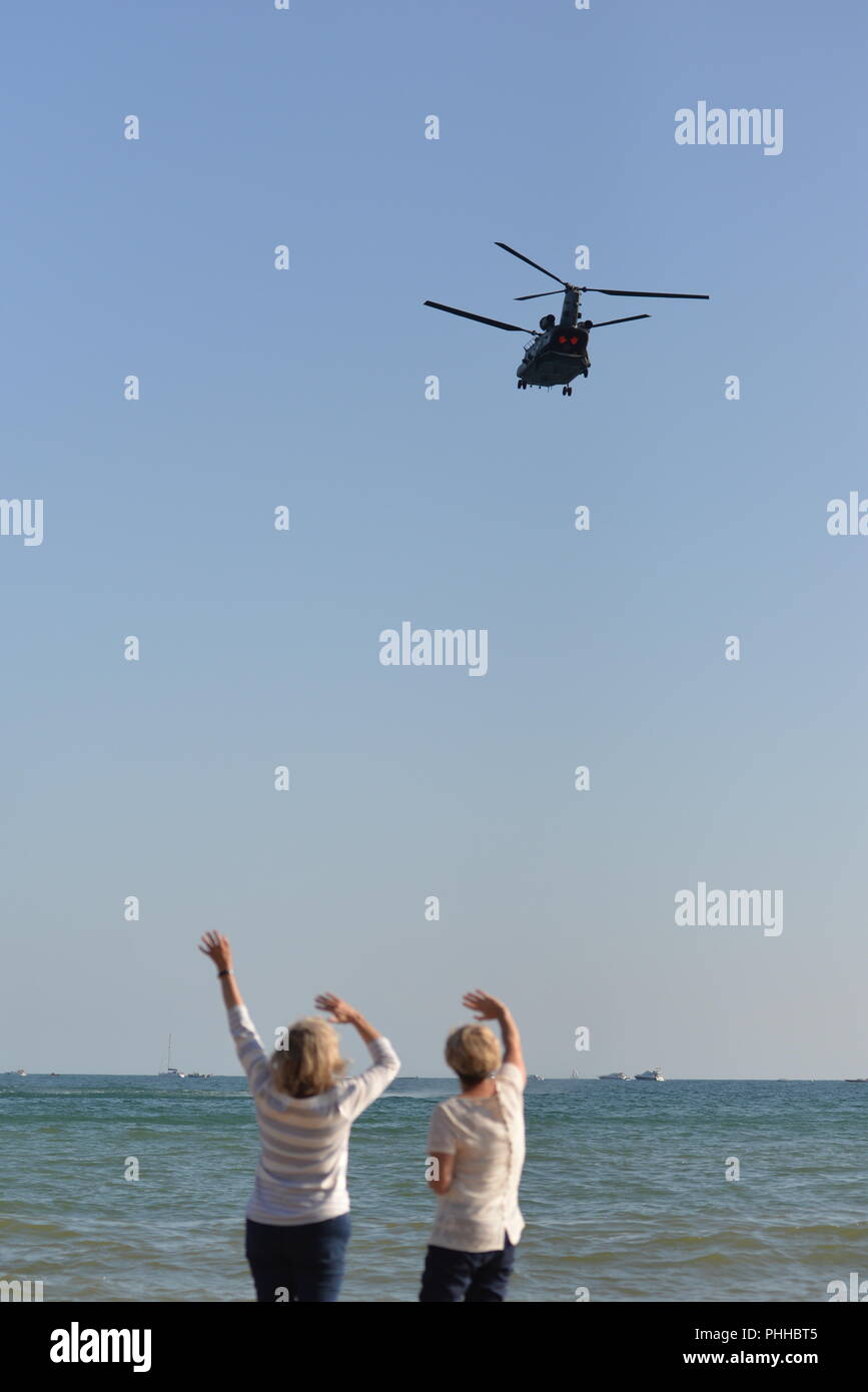Waving at a helicopter, Bournemouth Air Festival 2018 Stock Photo - Alamy