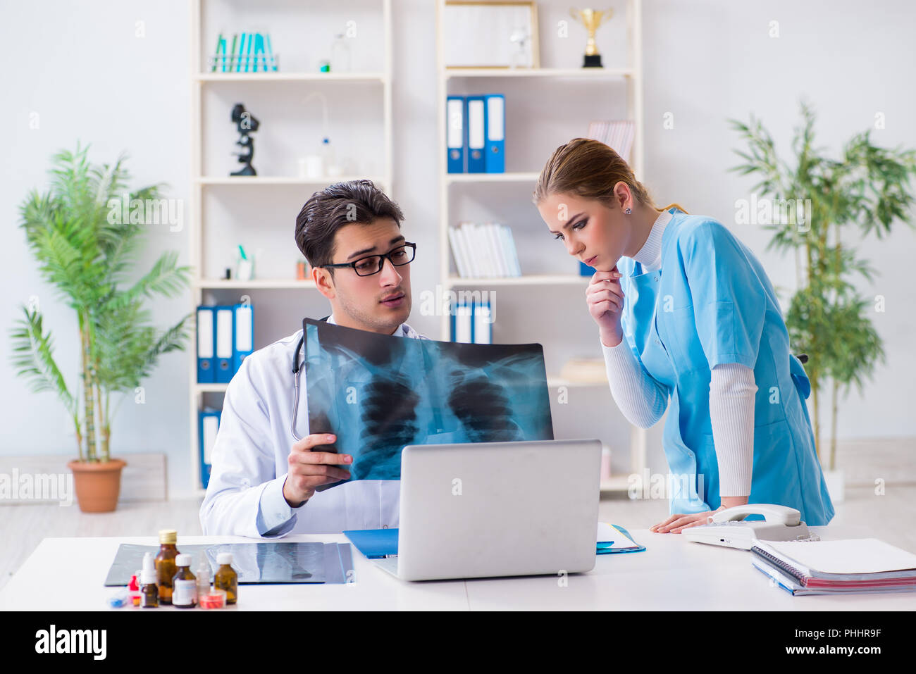 Two doctors examining x-ray images of patient for diagnosis Stock Photo ...