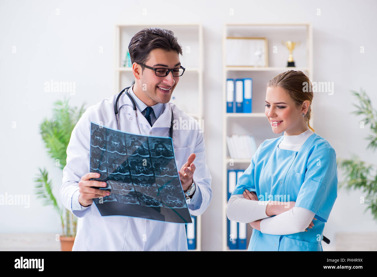 Two doctors examining x-ray images of patient for diagnosis Stock Photo ...