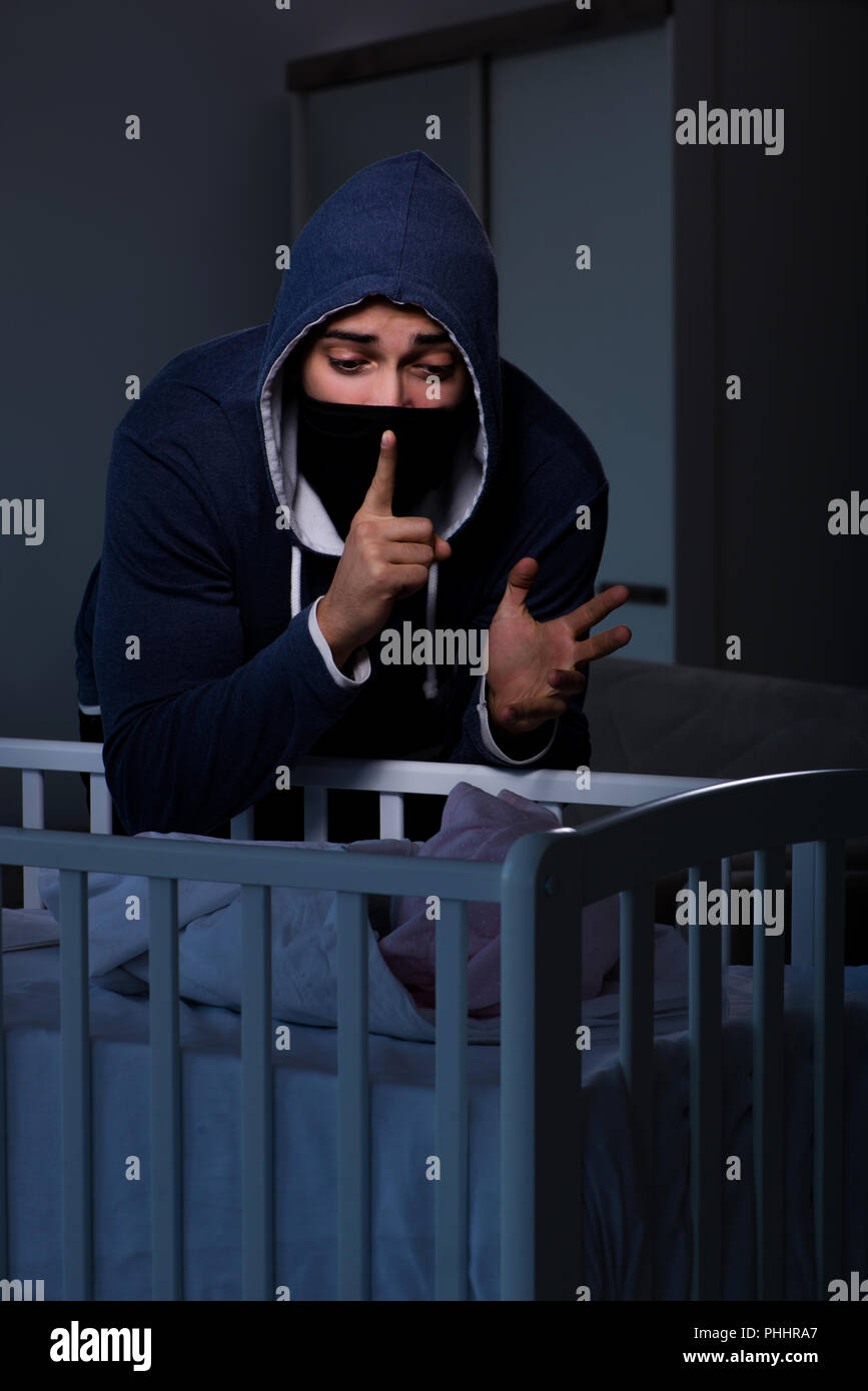 Criminal stealing baby in human child traficking concept Stock Photo ...
