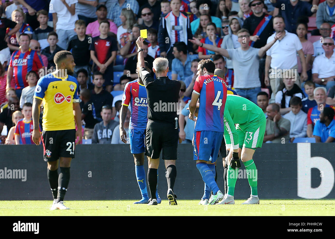 Match Referee Martin Atkinson shows a yellow card to Crystal Palace's ...