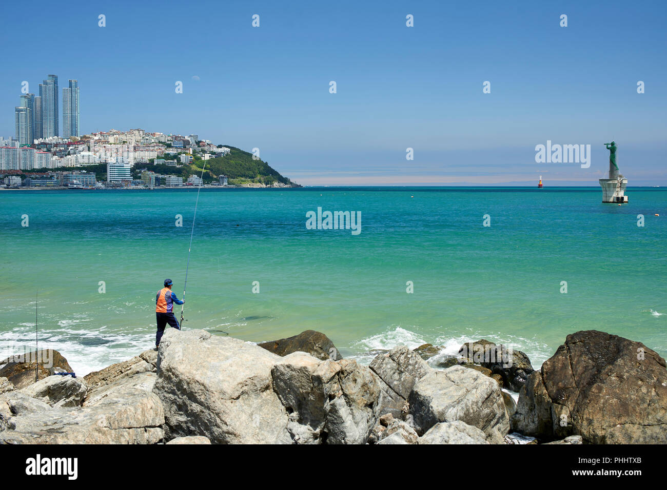 Fishing from the rugged rocky coastline of Haeundae Bay, Busan, Korea ...
