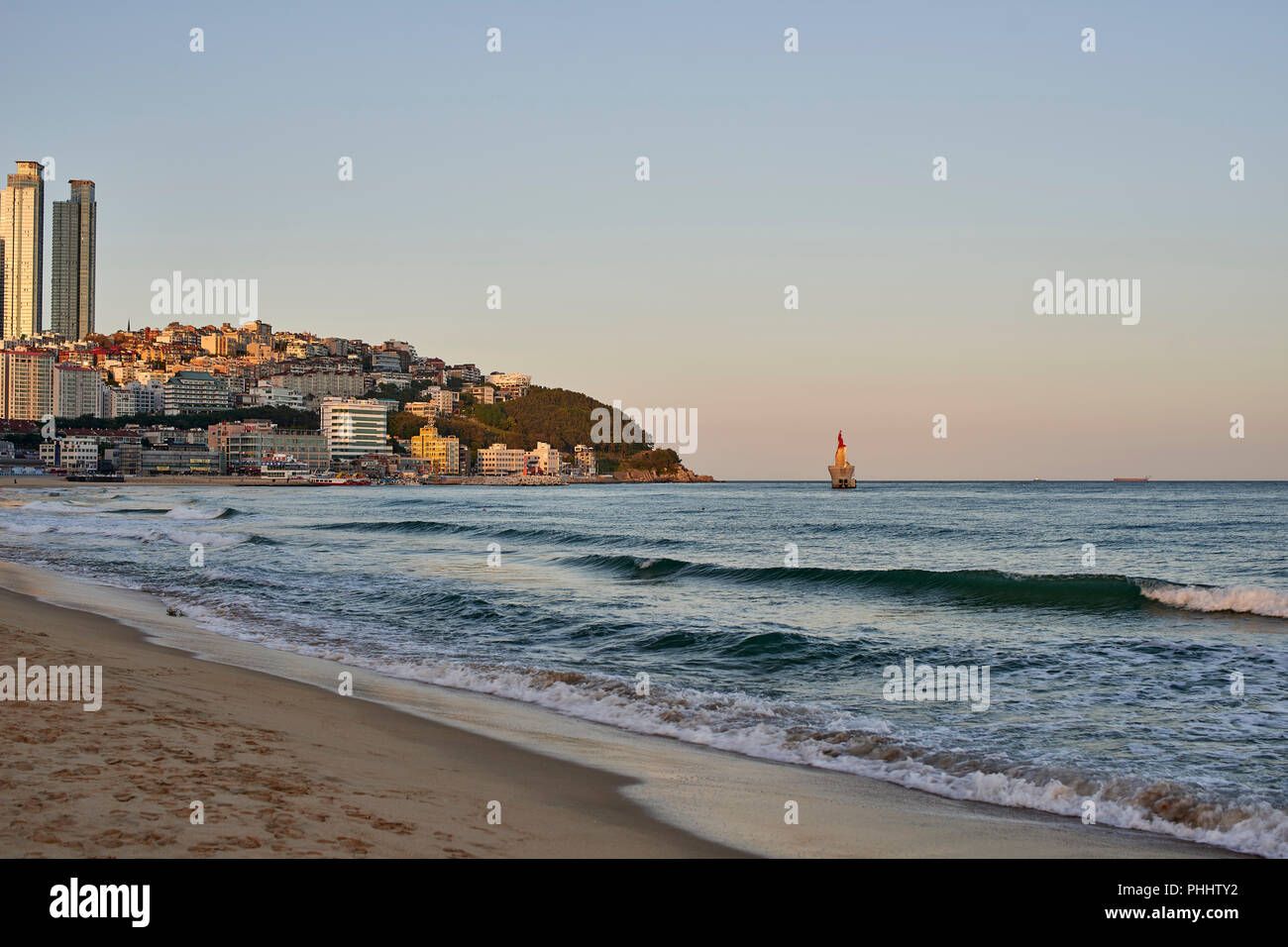 Haeundae Beach, Busan, Korea - late summer evening sun on light beacon ...