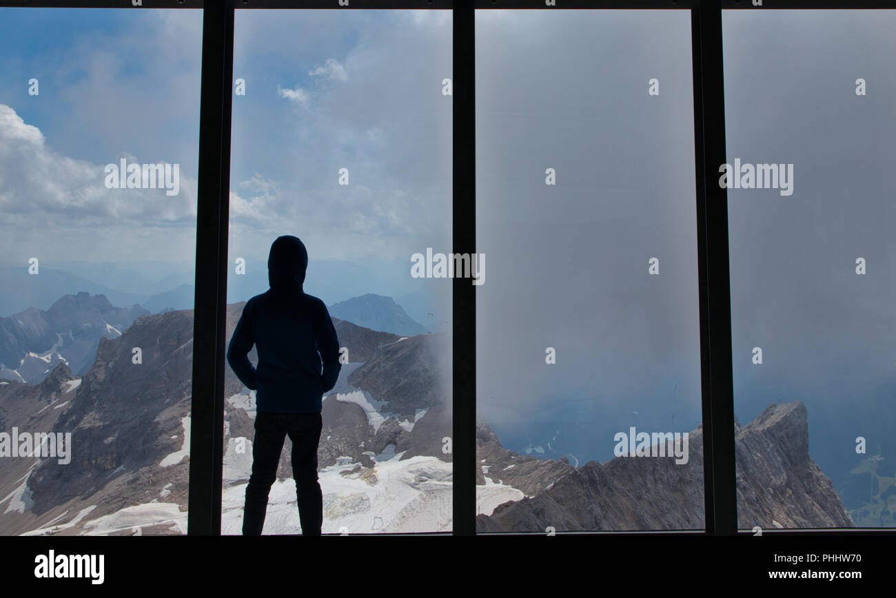 Boy watching out the window seeing mountains Stock Photo - Alamy