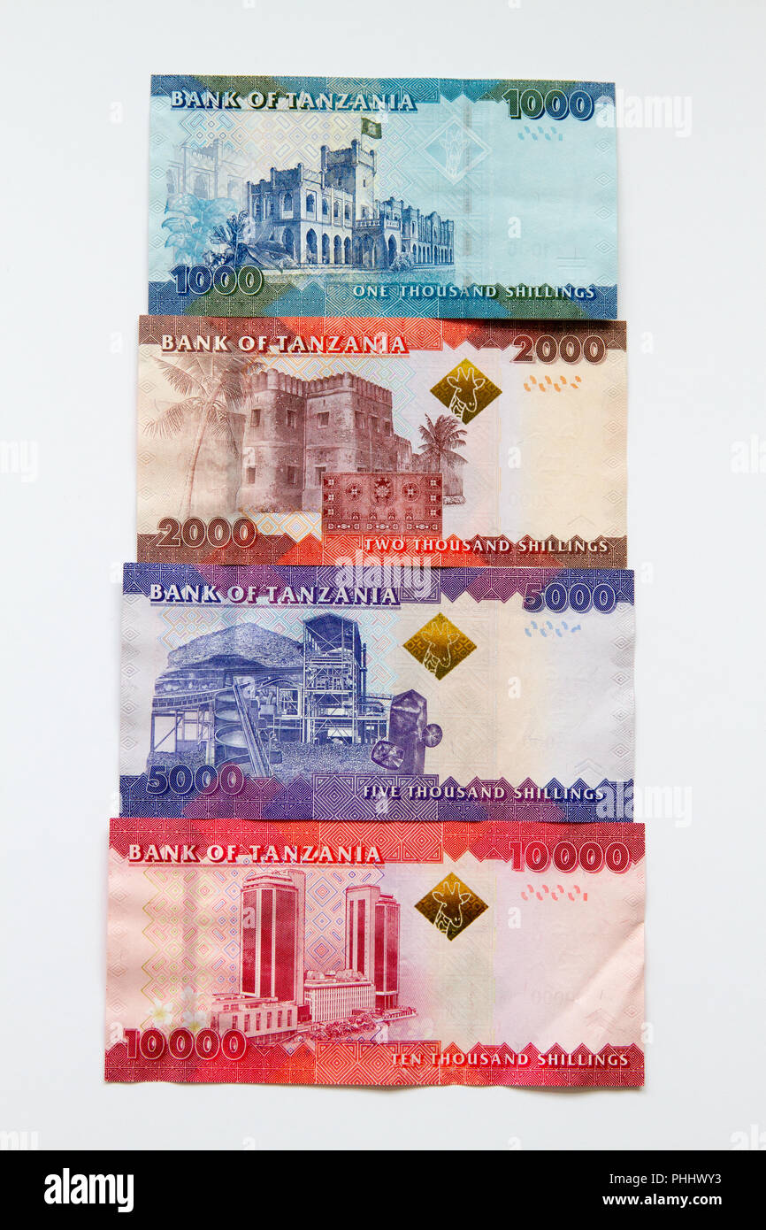 Colorful background of mixed banknotes and coins of Tanzanian Shilling ...
