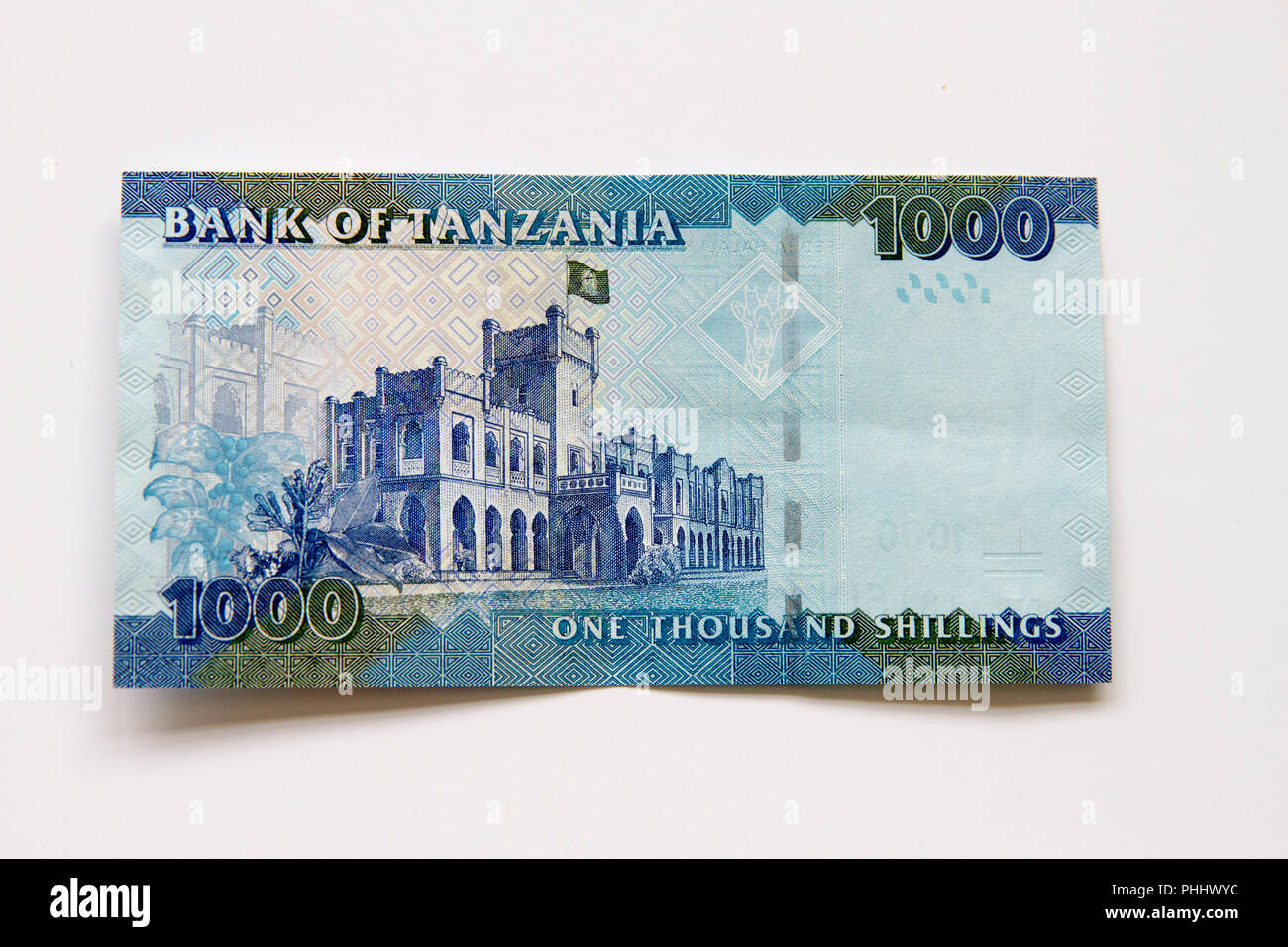 Colorful background of mixed banknotes and coins of Tanzanian Shilling ...
