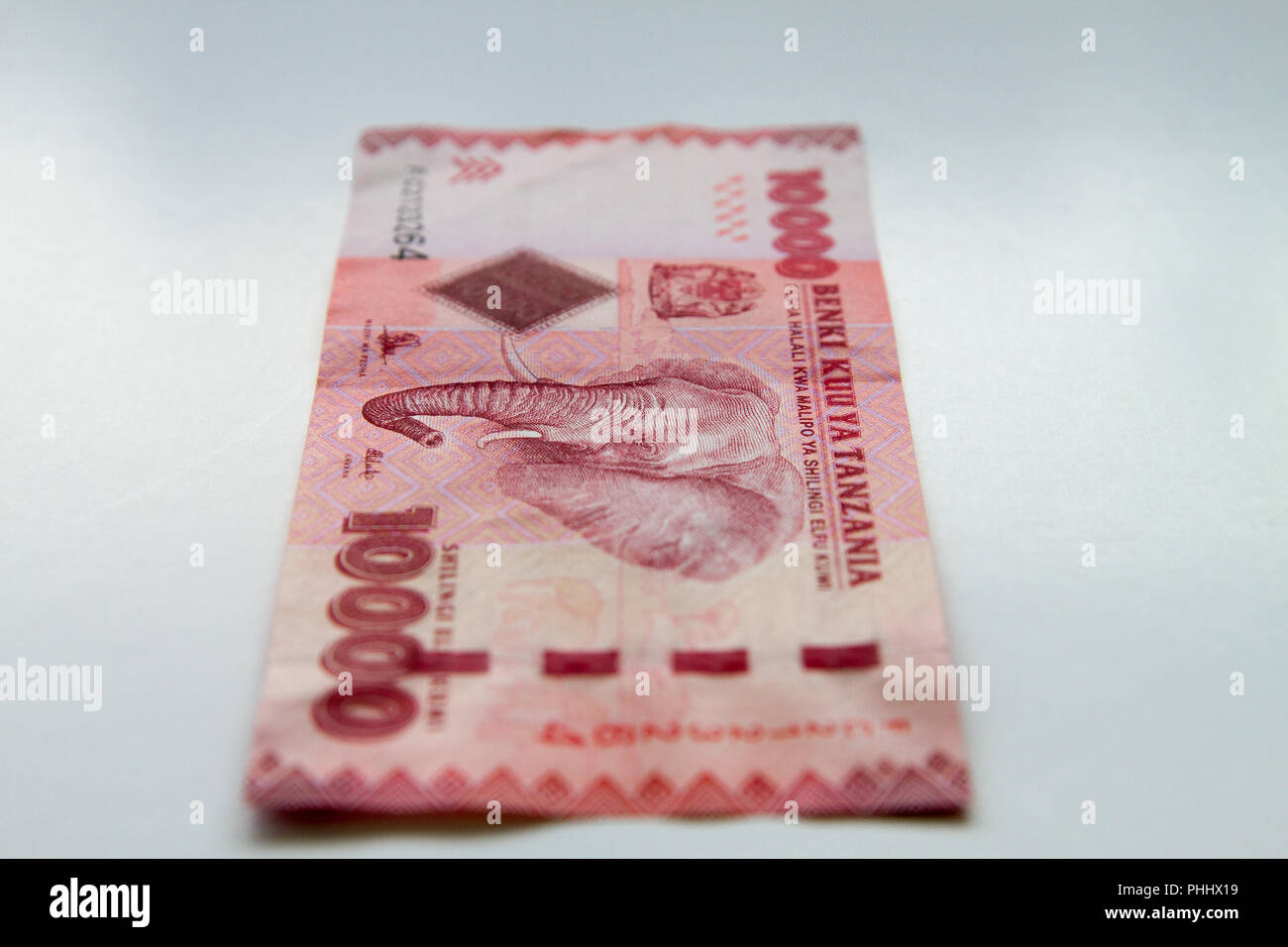 Colorful background of mixed banknotes and coins of Tanzanian Shilling ...