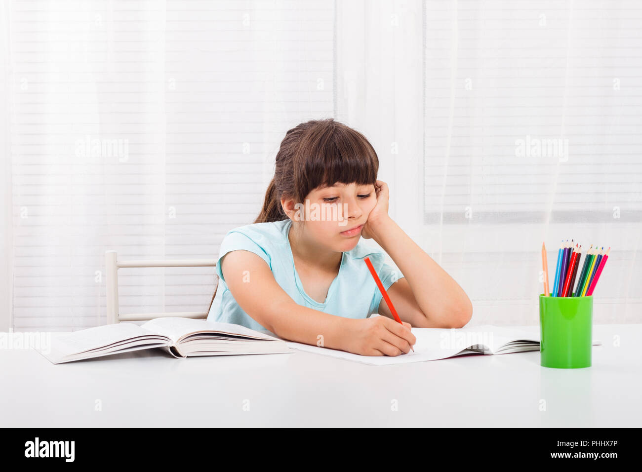 Little girl must stay at home and do her homework,but she would rather ...