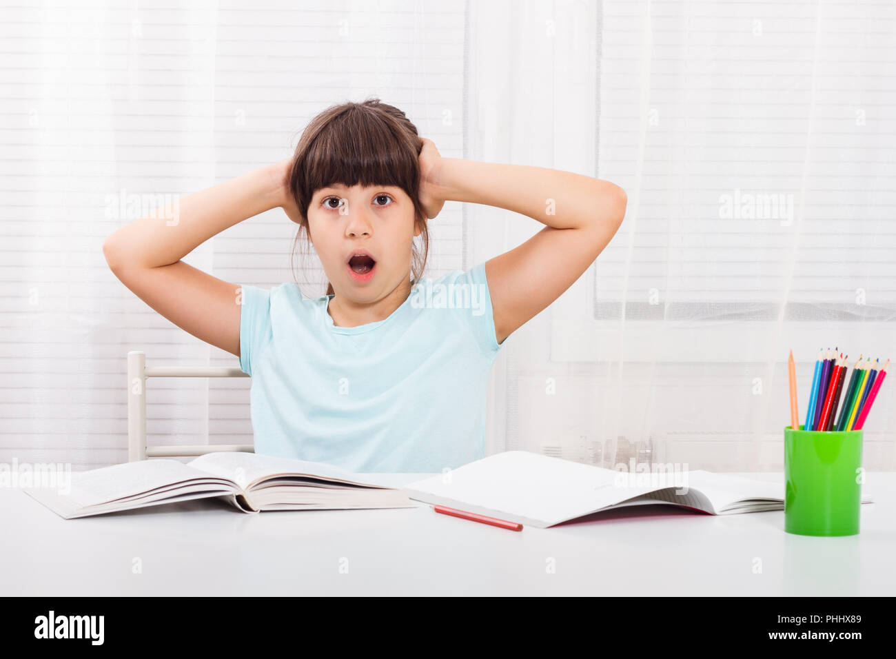 Little girl is in panic because of her homework Stock Photo - Alamy