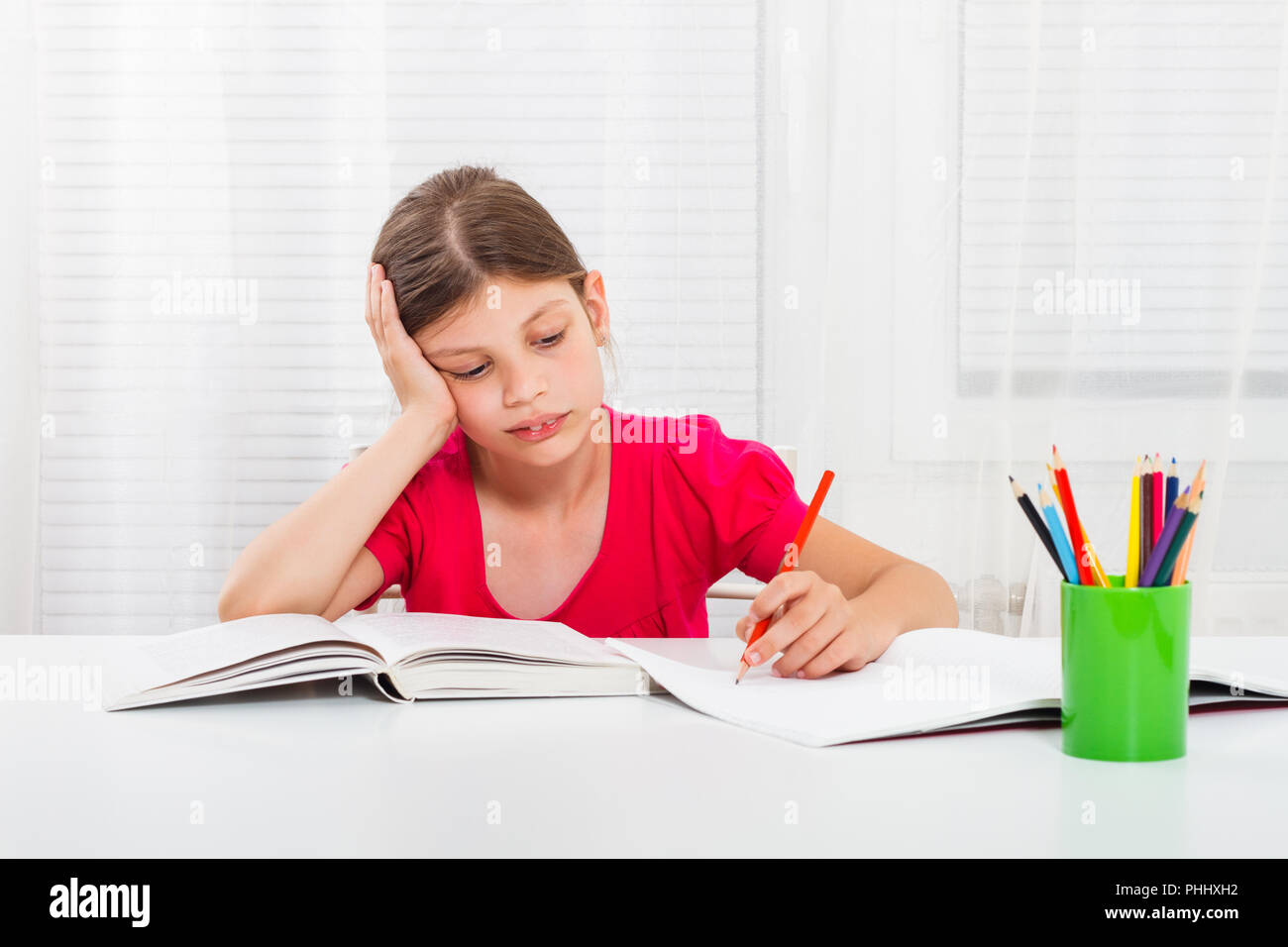 Little girl must stay at home and do her homework,but she would rather ...