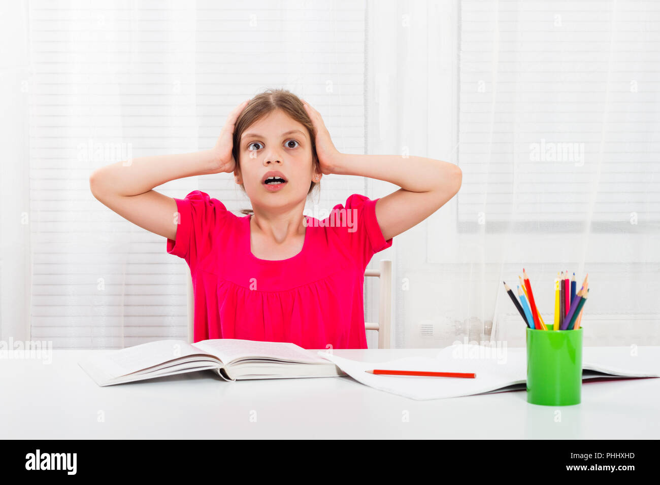 Little girl is in panic because of her homework Stock Photo - Alamy