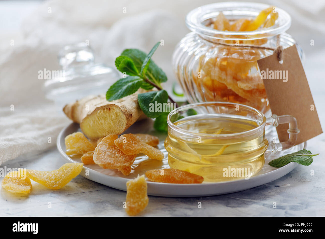 Ginger tea and slices of candied ginger closeup Stock Photo - Alamy