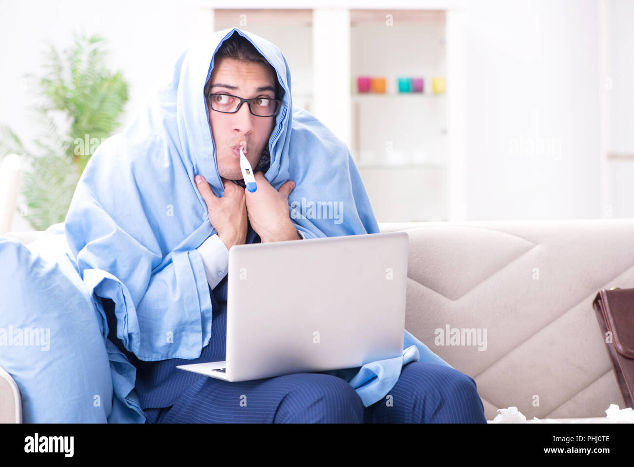 Sick businessman laptop computer temperature hi-res stock photography ...
