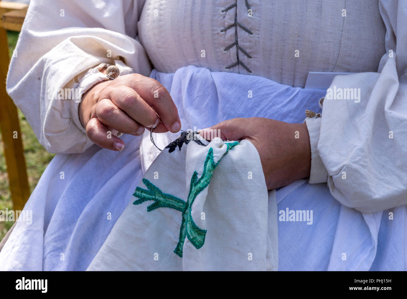 Old lady sewing outdoor - handmade traditional Stock Photo - Alamy