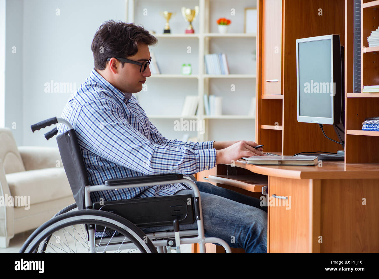 Disabled student studying at home on wheelchair Stock Photo - Alamy