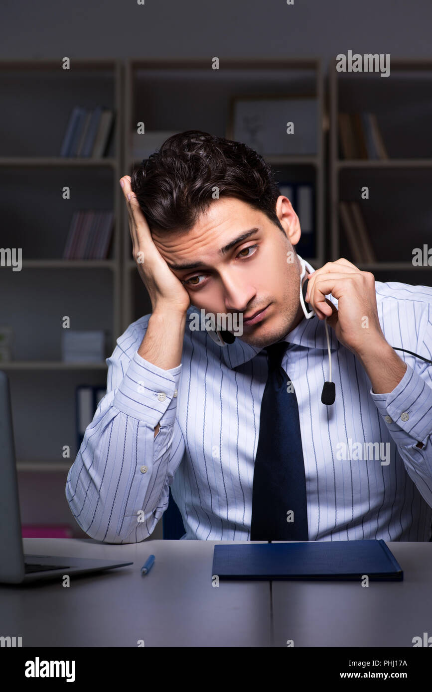 Tired and exhausted helpdesk operator during night shift Stock Photo ...