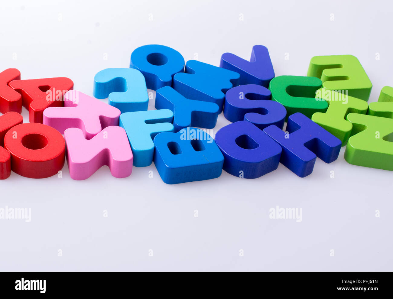 Colorful alphabet letter blocks scattered randomly on white background ...