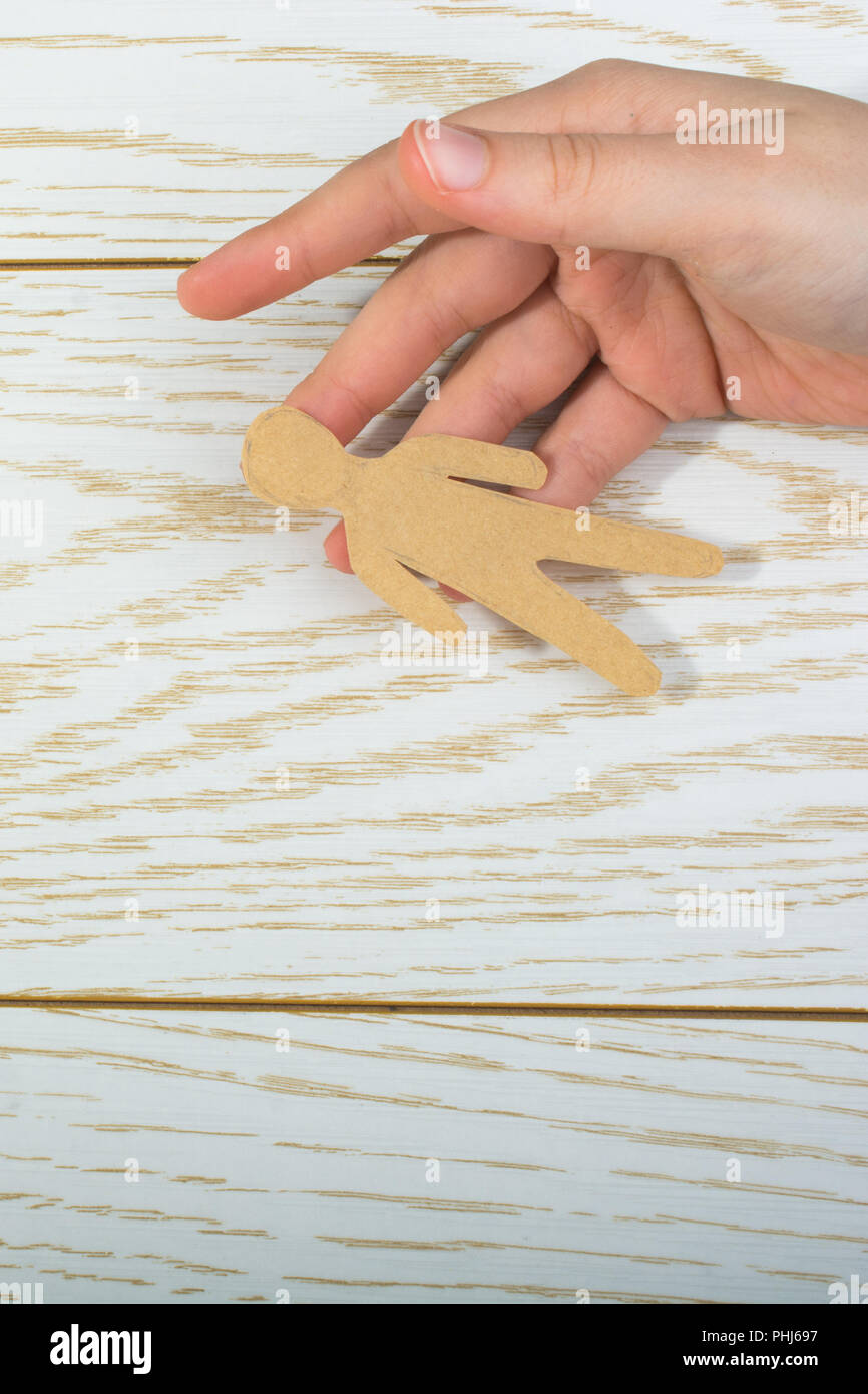 Man shape cut out of paper in hand in the view Stock Photo - Alamy