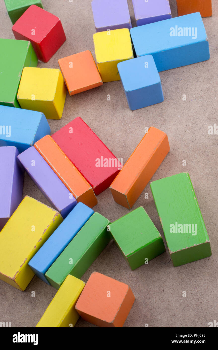 Colorful building blocks on a brown background Stock Photo - Alamy