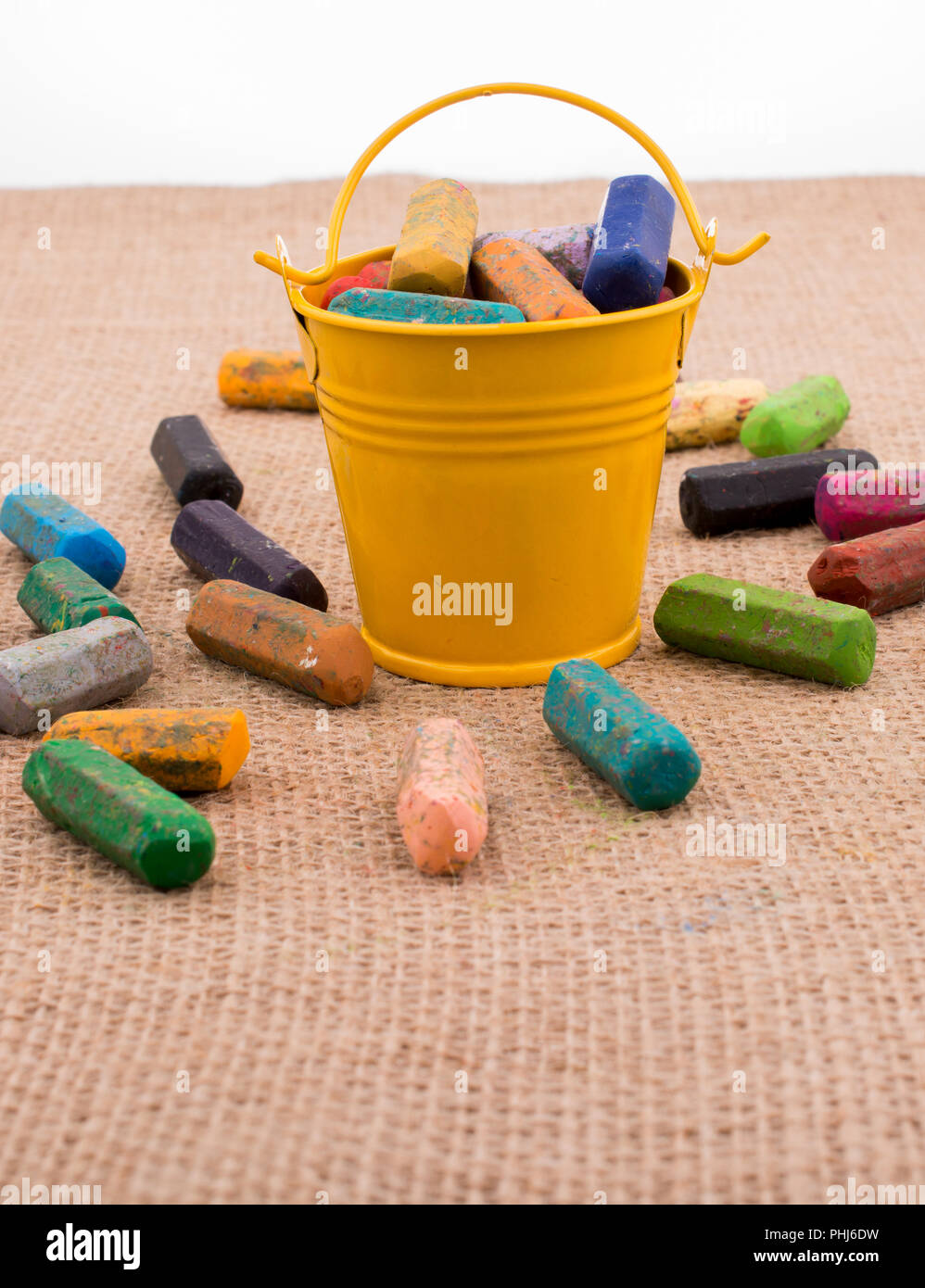 Crayons of various color in a bucket on a canvas Stock Photo - Alamy