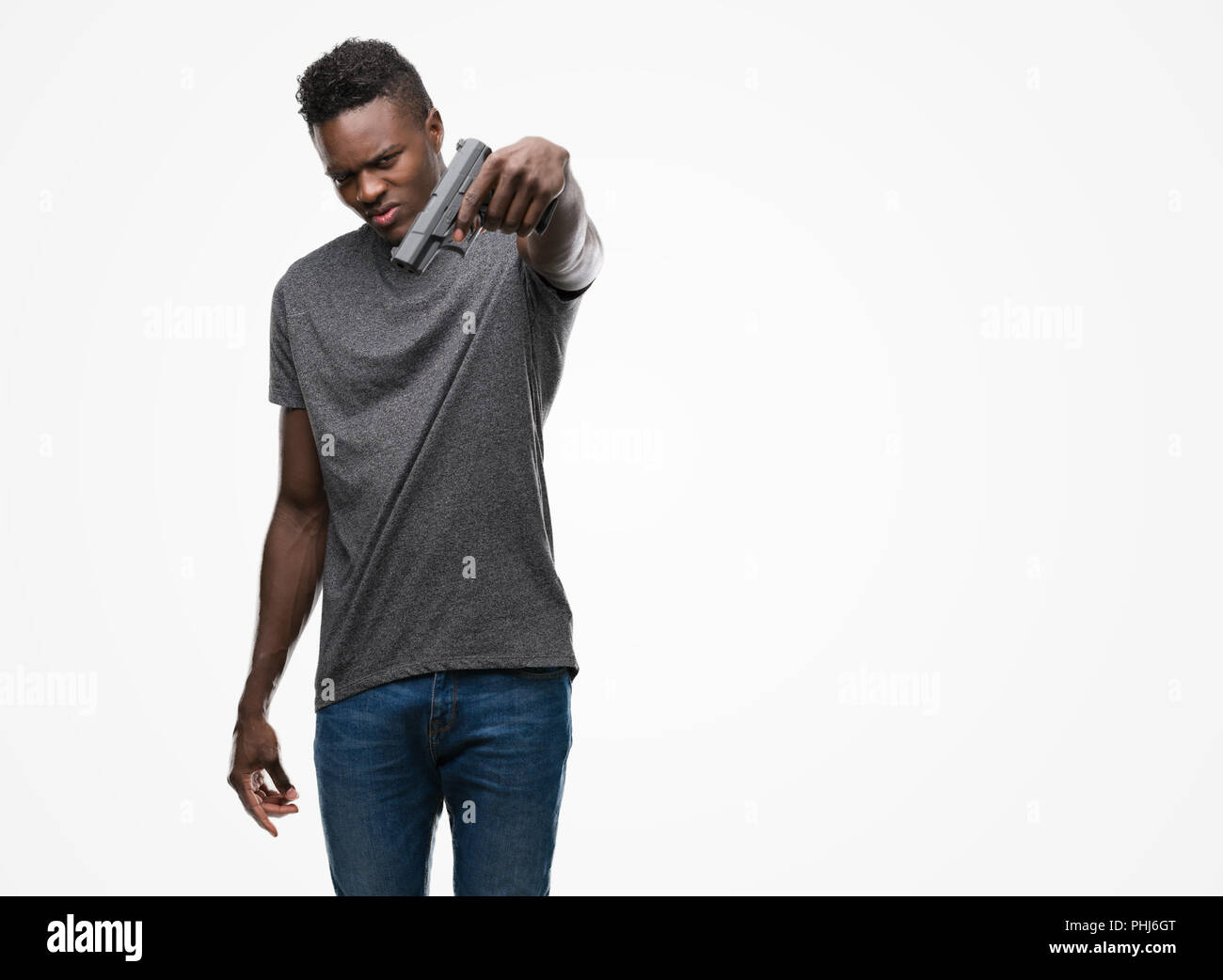 Young african american man holding a gun with a confident expression on ...