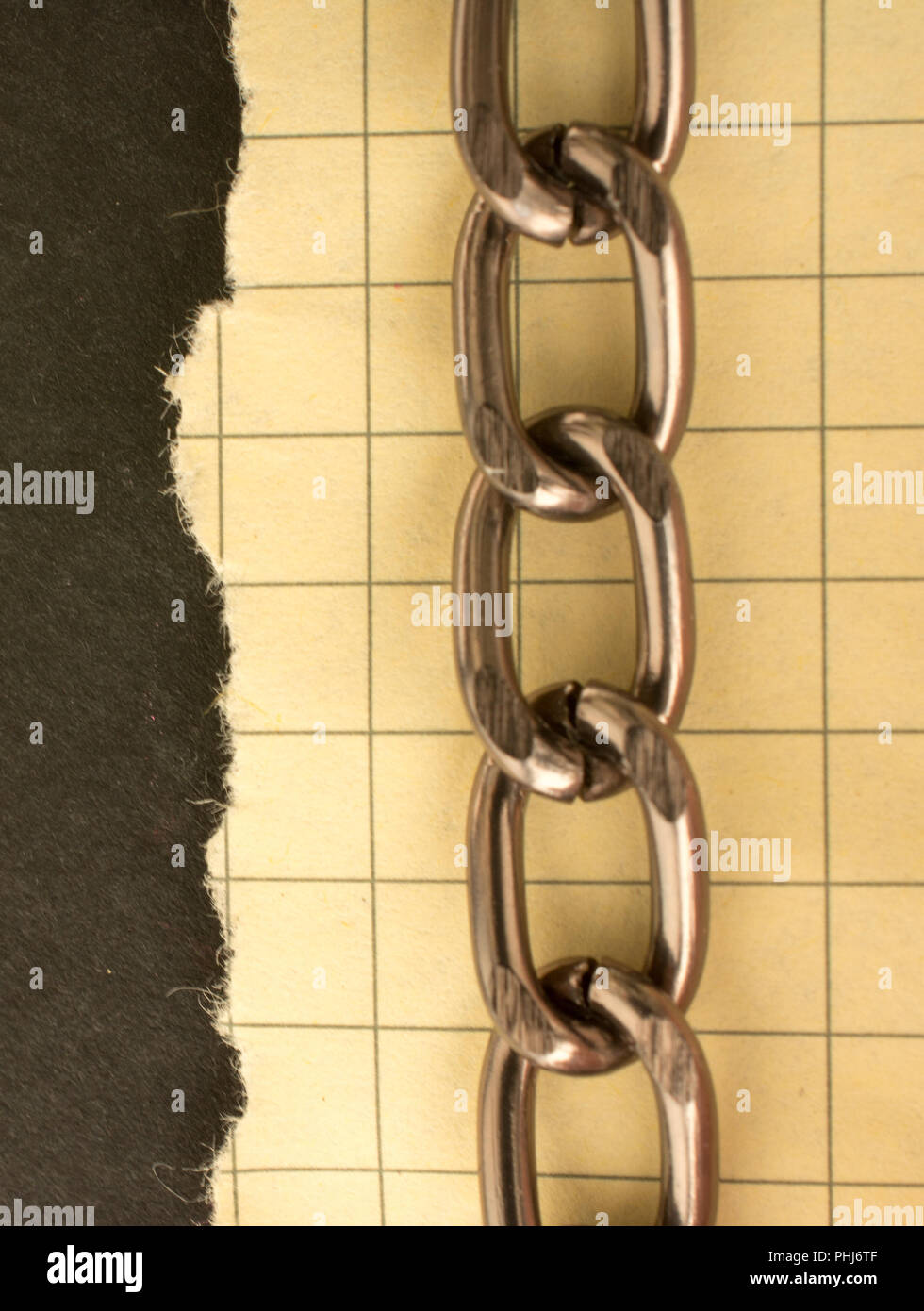 Chain and torn paper on a dark background Stock Photo - Alamy