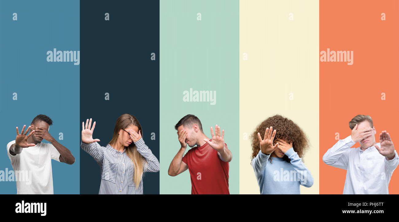 Group of people over vintage colors background covering eyes with hands ...