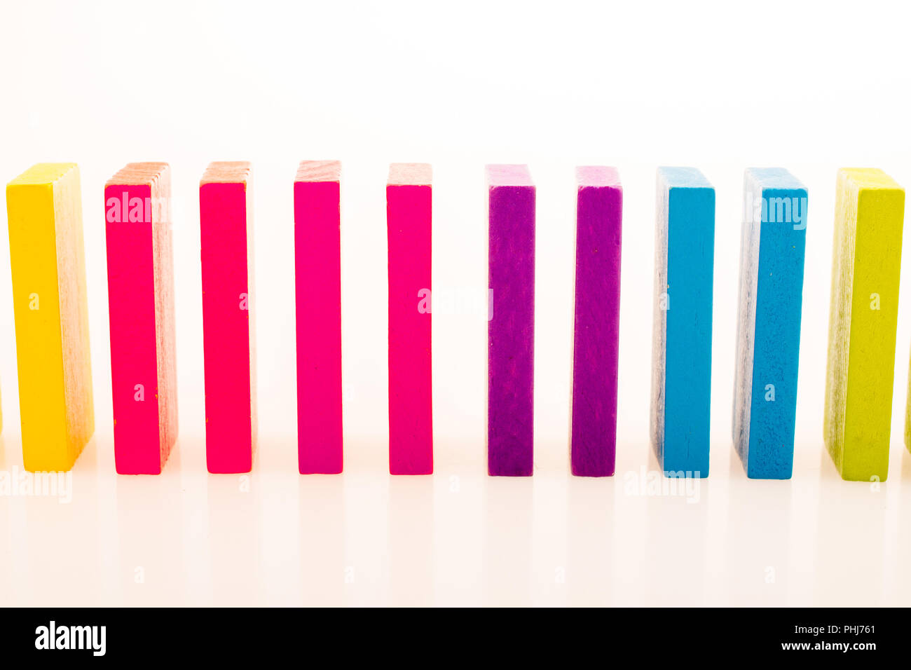 Colorful Domino Blocks in a line on a white background Stock Photo - Alamy