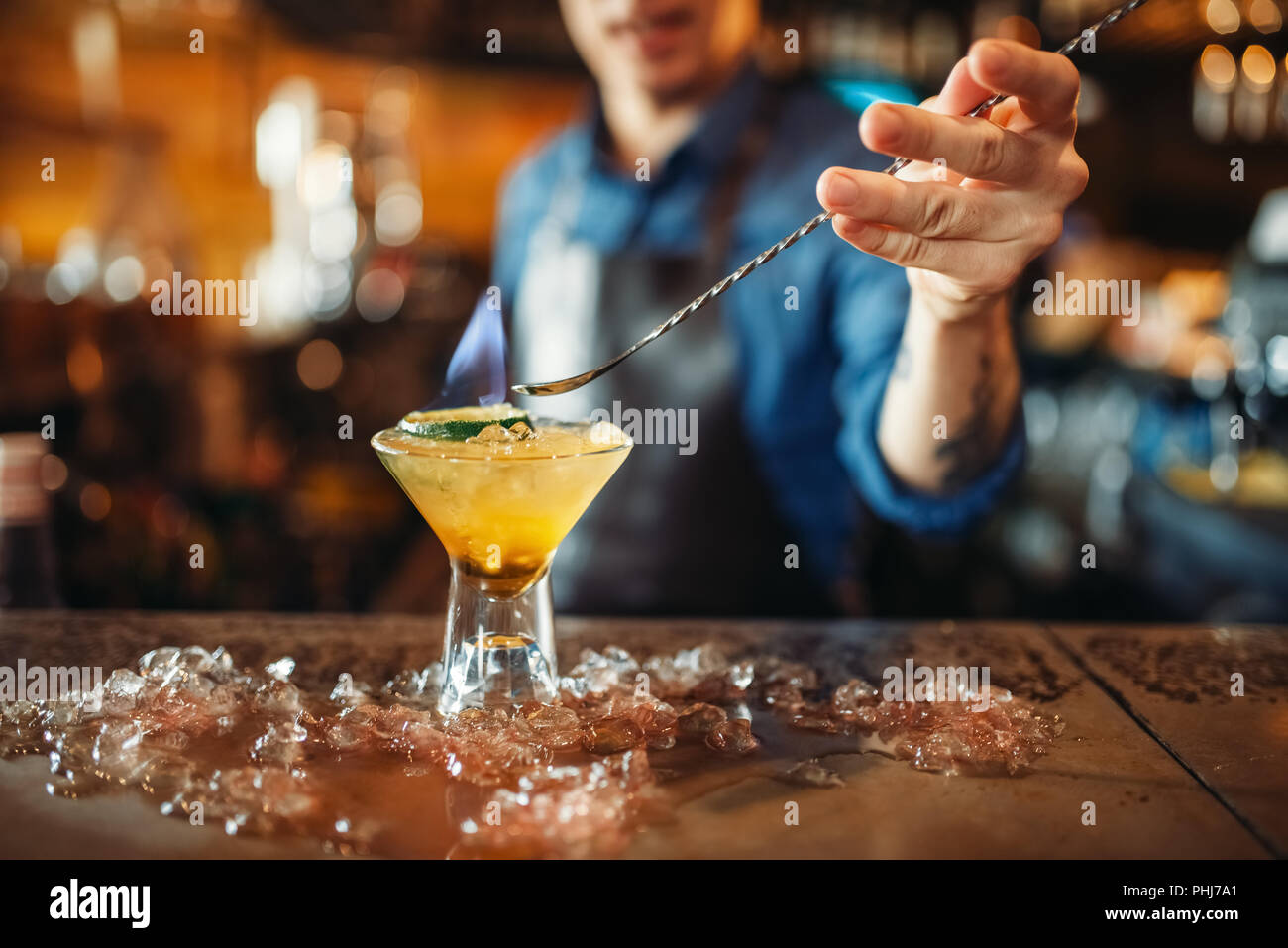 Male bartender prepares alcoholic coctail with ice. Barkeeper ...