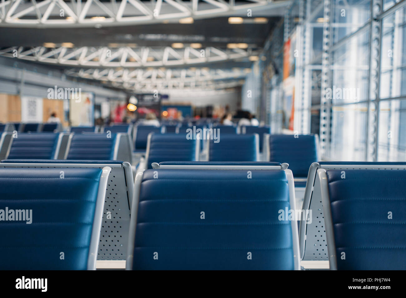 Row of seats in airport waiting zone, nobody. Departure area of air ...