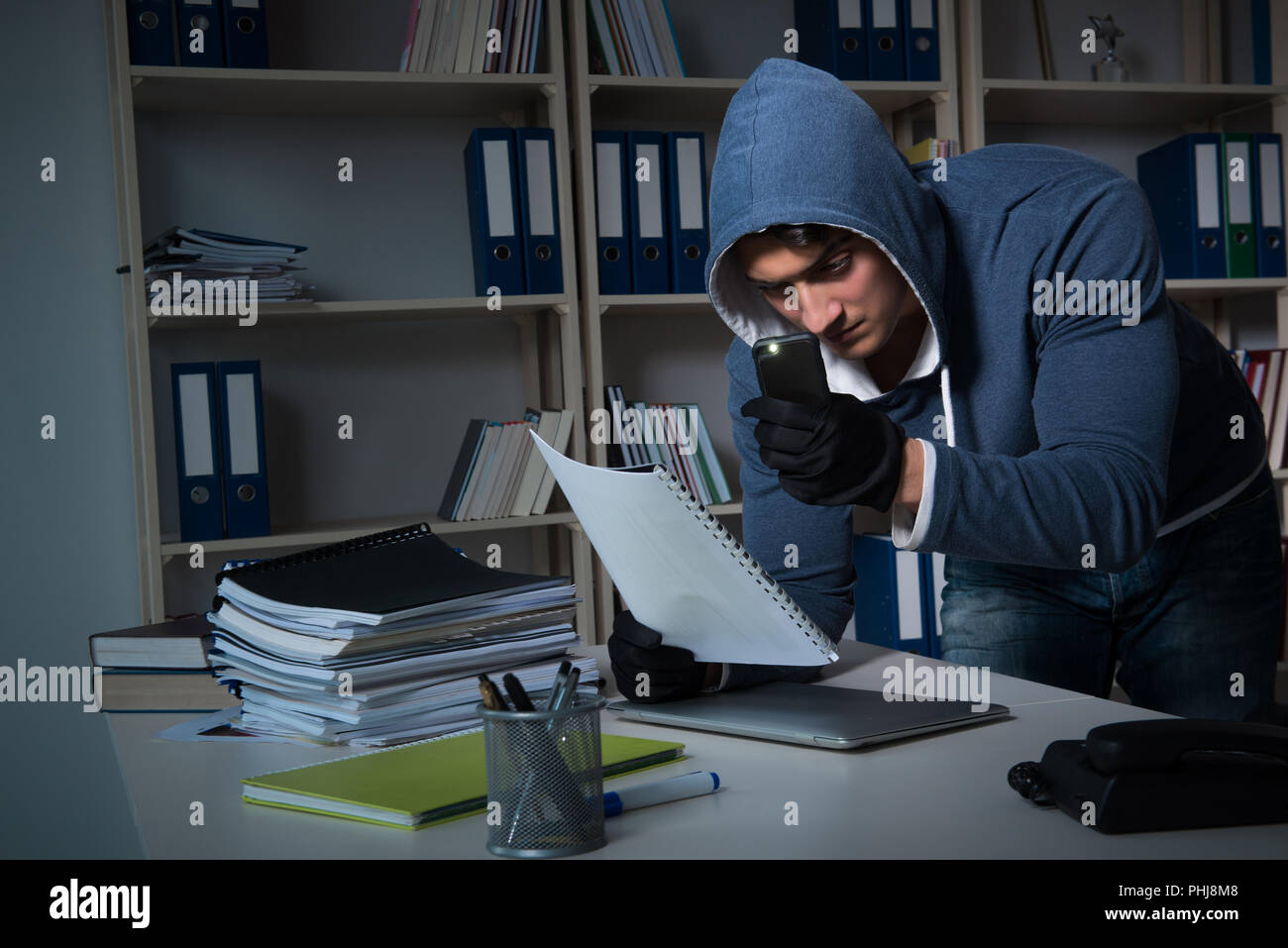 Young man in industrial espionage concept Stock Photo - Alamy