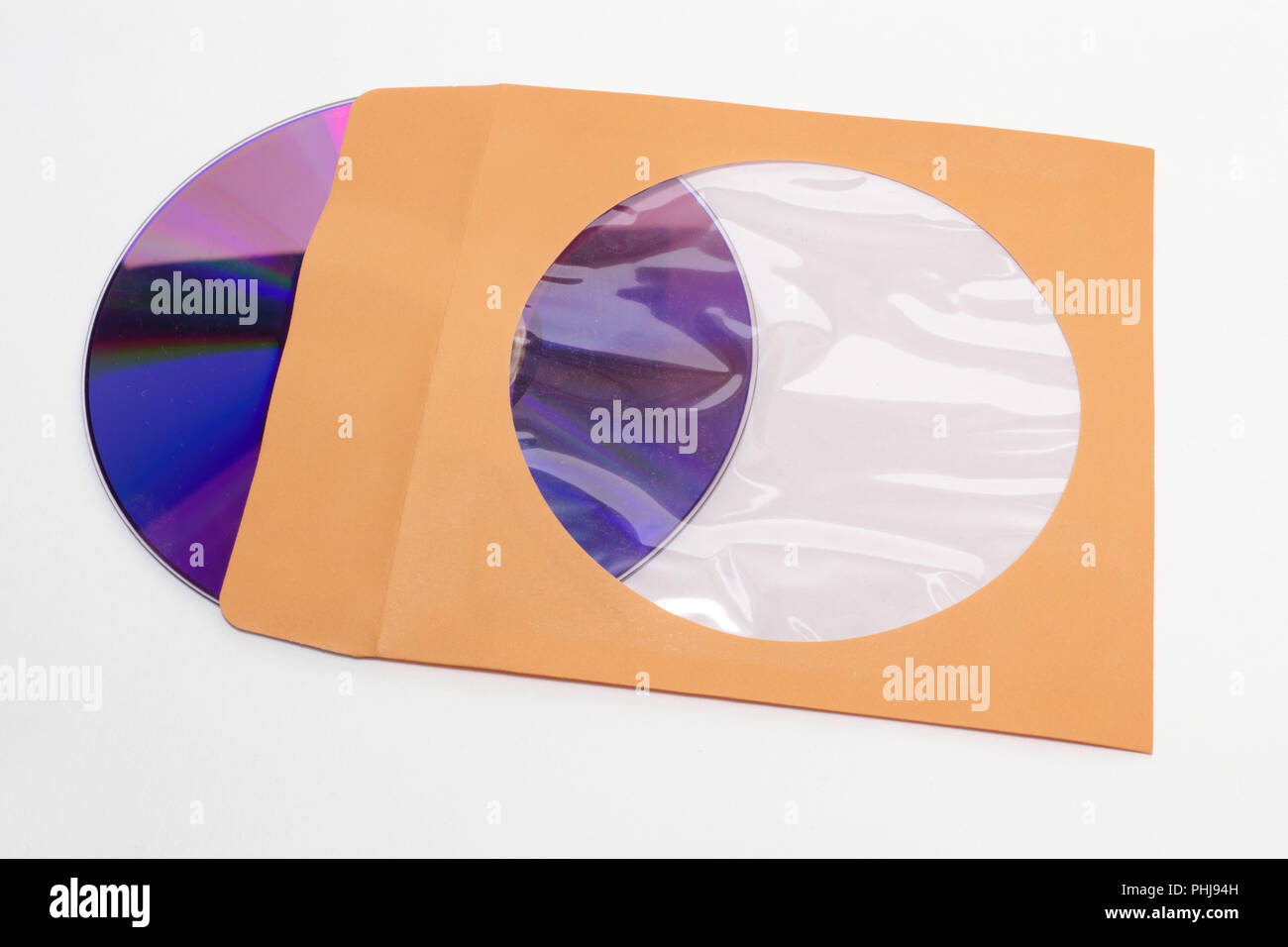 DVD compact disc sticking out of orange paper envelope with flap and ...