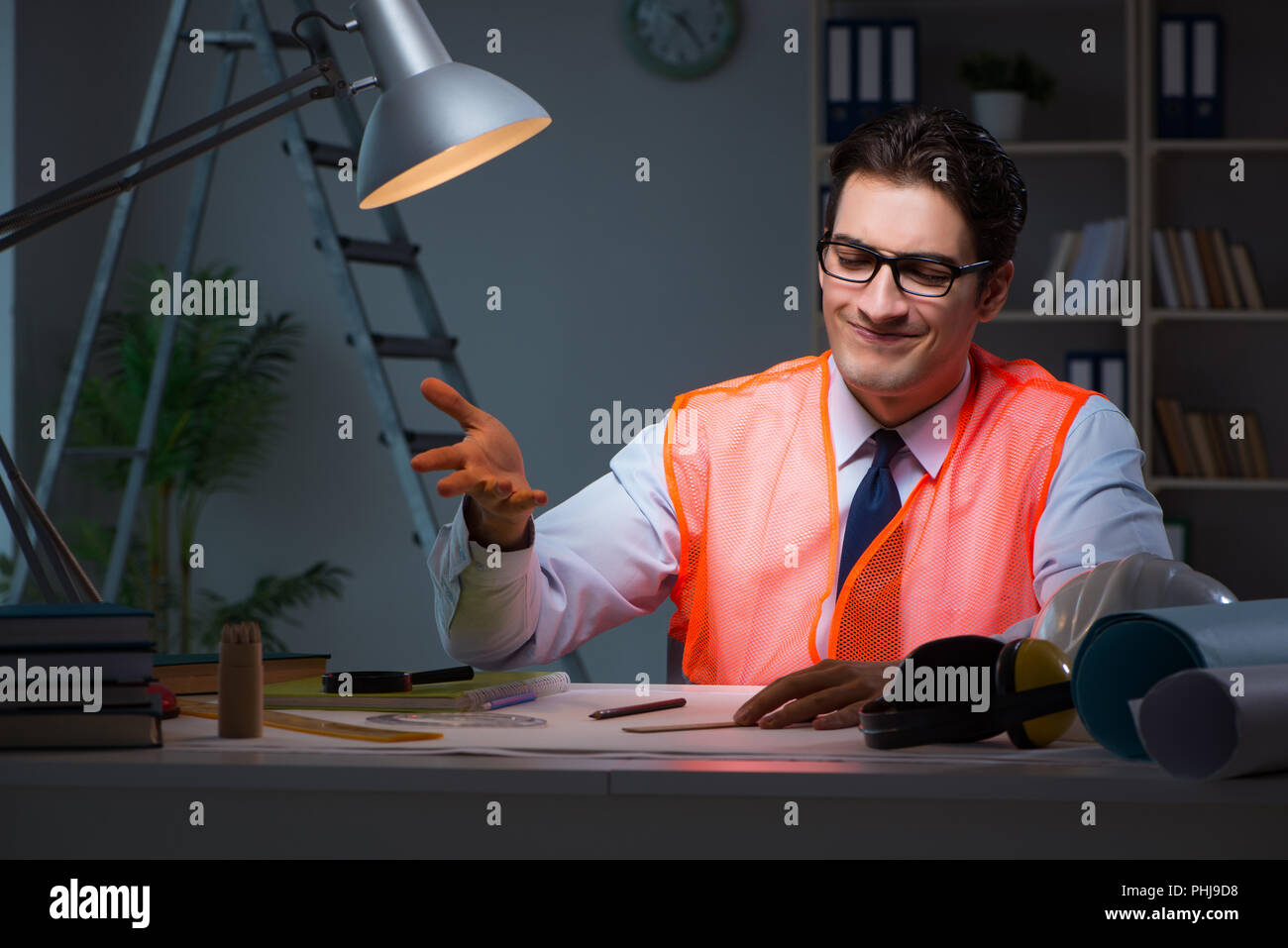 Construction architect working on drawings late at night Stock Photo ...
