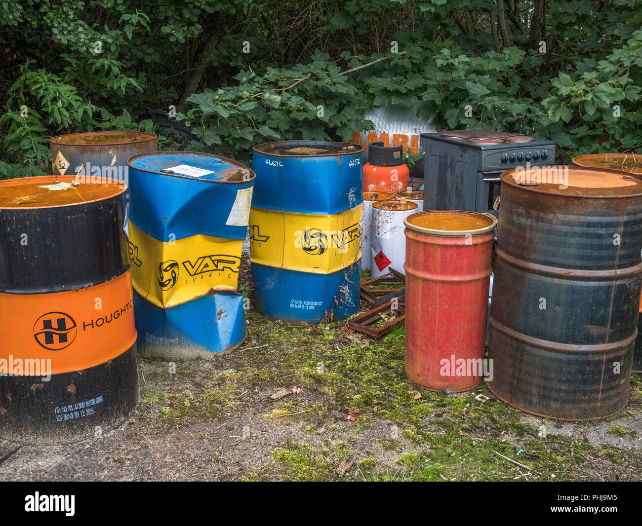 Empty industrial lubricant steel barrels awaiting disposal Stock Photo ...