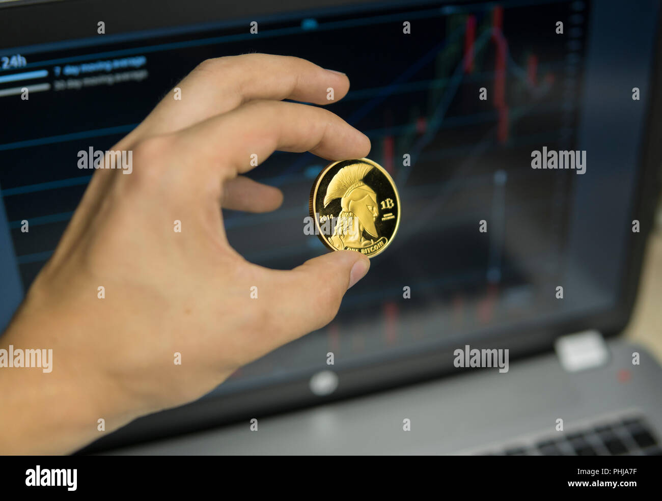 Male businessman hand holding titan bitcoin on a background of growth ...
