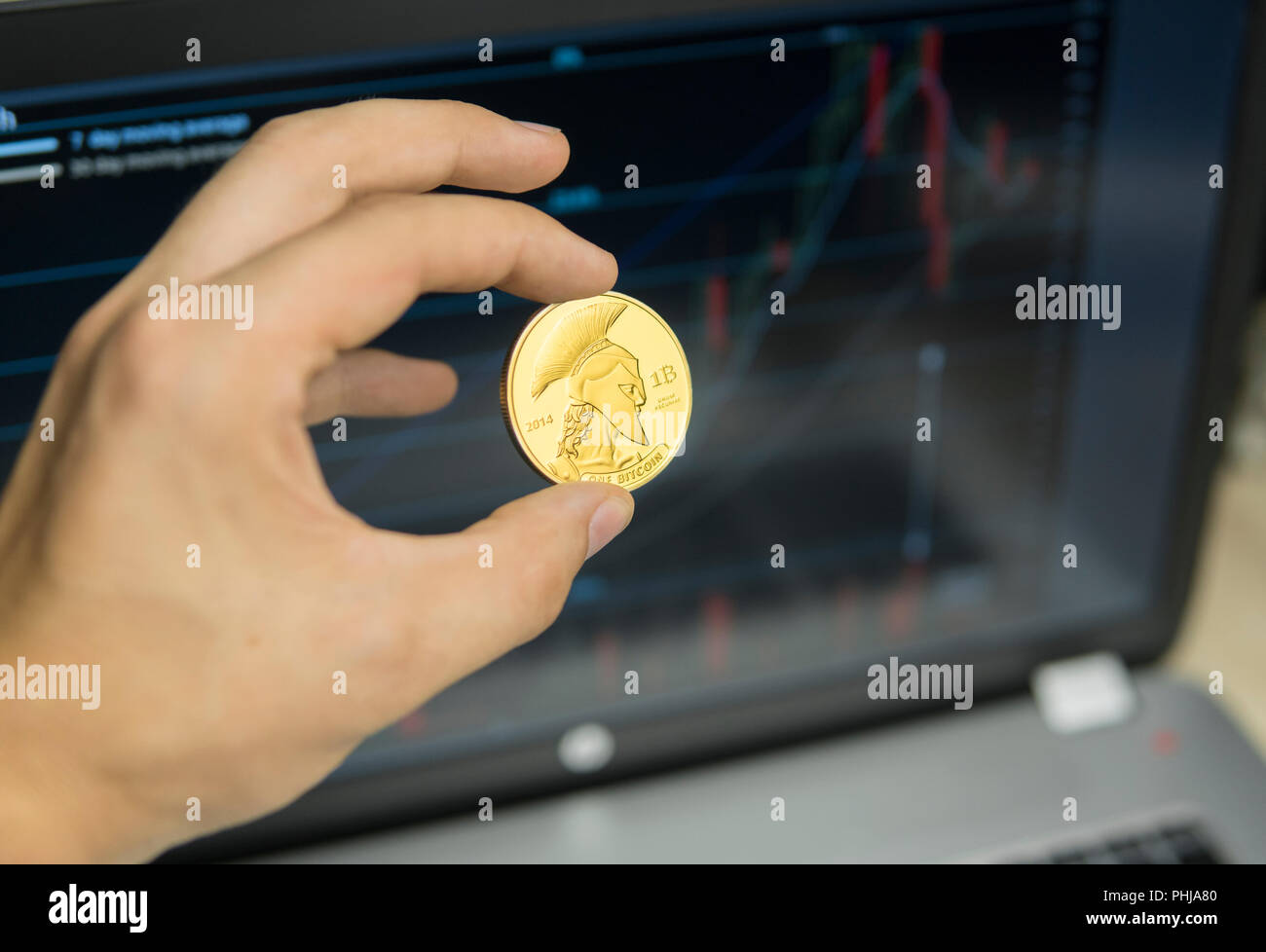 Male businessman hand holding titan bitcoin on a background of growth ...