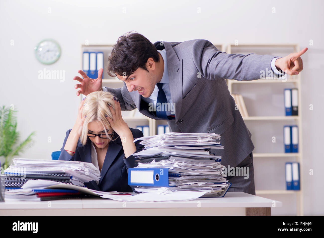 Angry irate boss yelling and shouting at his secretary employee Stock ...