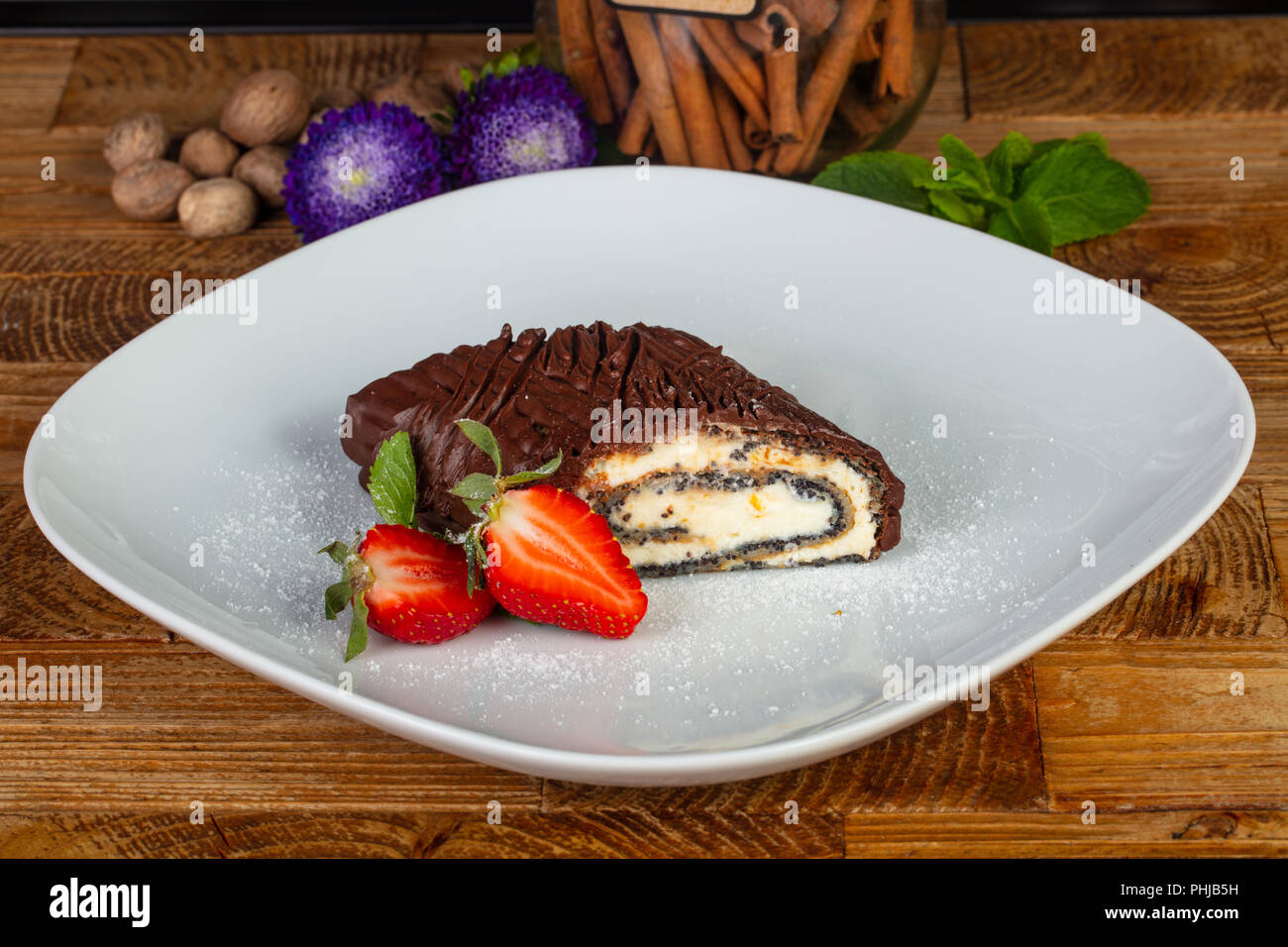 Delicious chocolate poppy roll with strawberry Stock Photo - Alamy