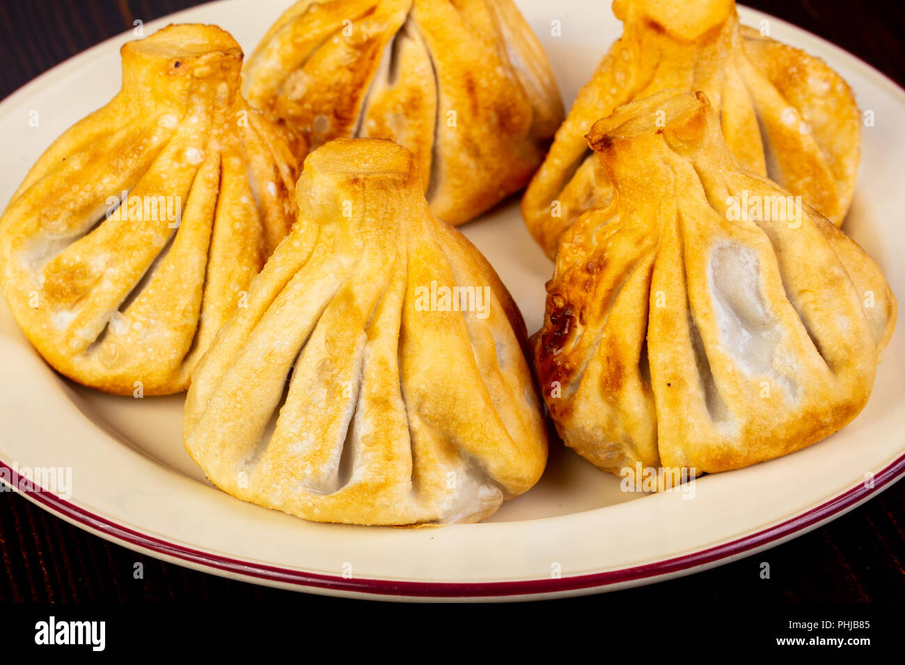 Roasted meat khinkali in the bowl Stock Photo - Alamy