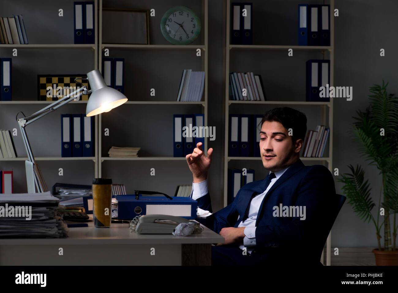 Employee working late to finish important deliverable task Stock Photo ...