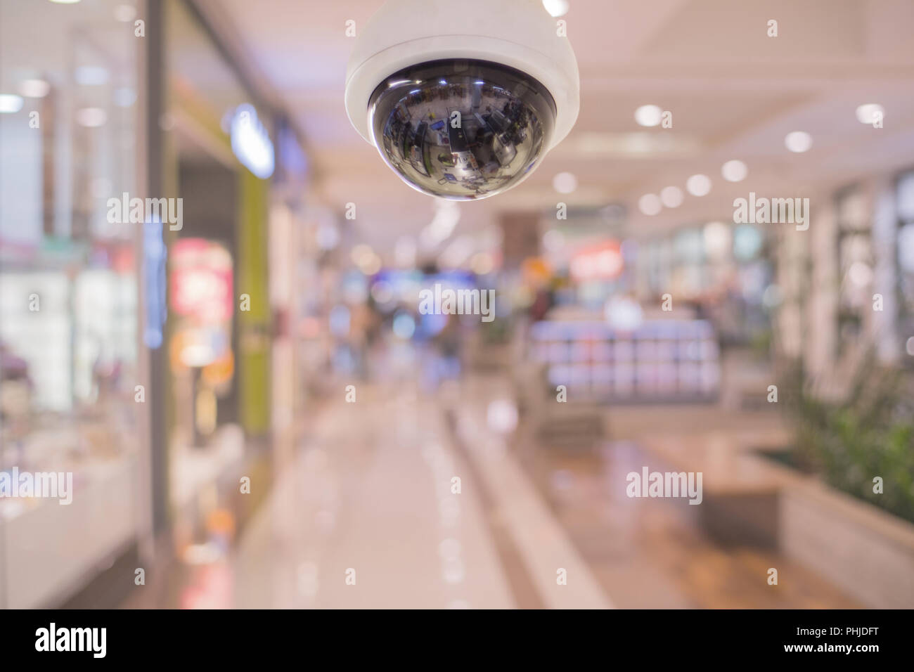 CCTV and blurred mall stores blur background. Business protection Stock ...